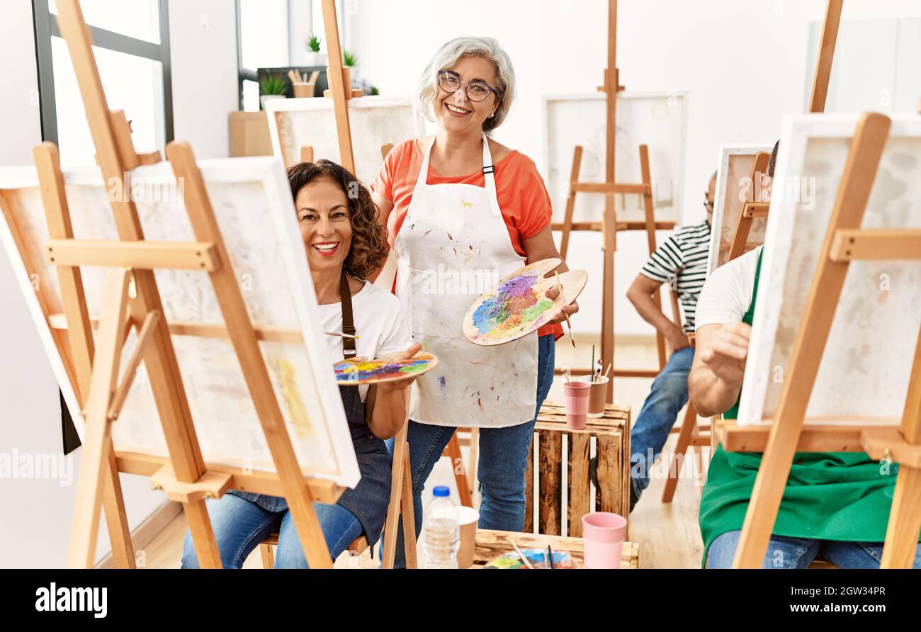 Group of middle age draw students drawing at art studio. Teacher and ...