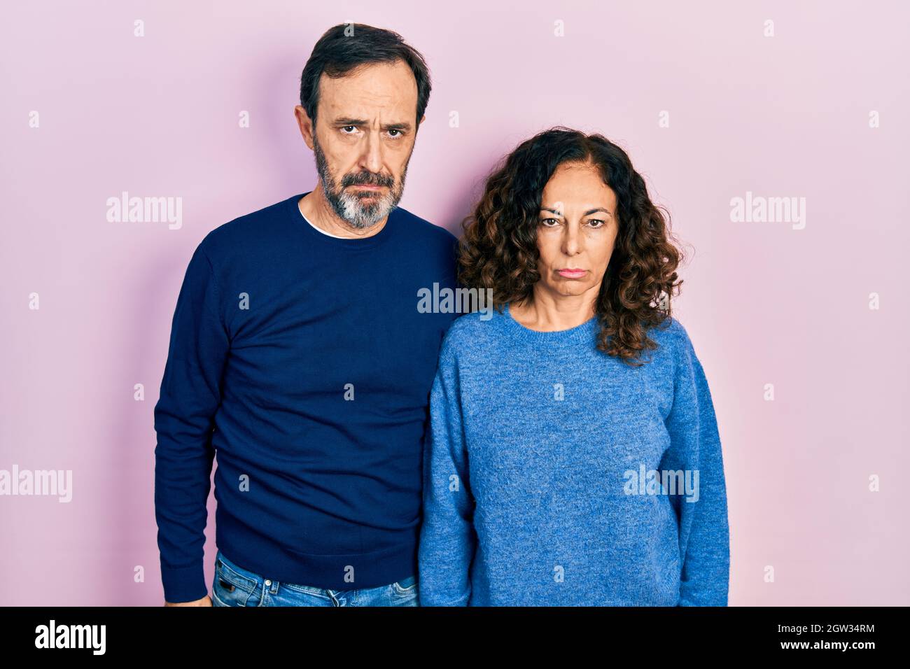 Middle age couple of hispanic woman and man hugging and standing ...