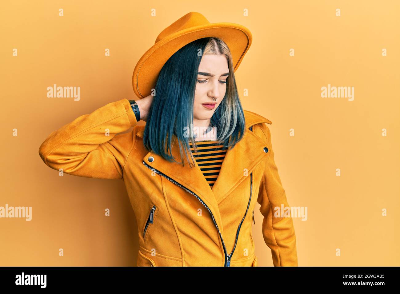 Young modern girl wearing yellow hat and leather jacket suffering of ...