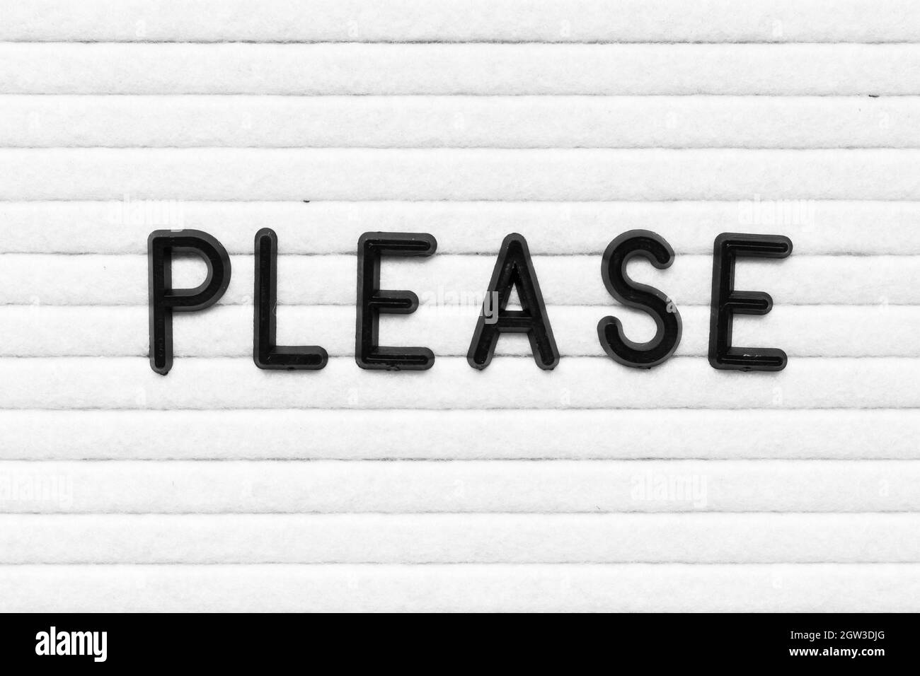 Black alphabet letter in word please on white felt board background ...