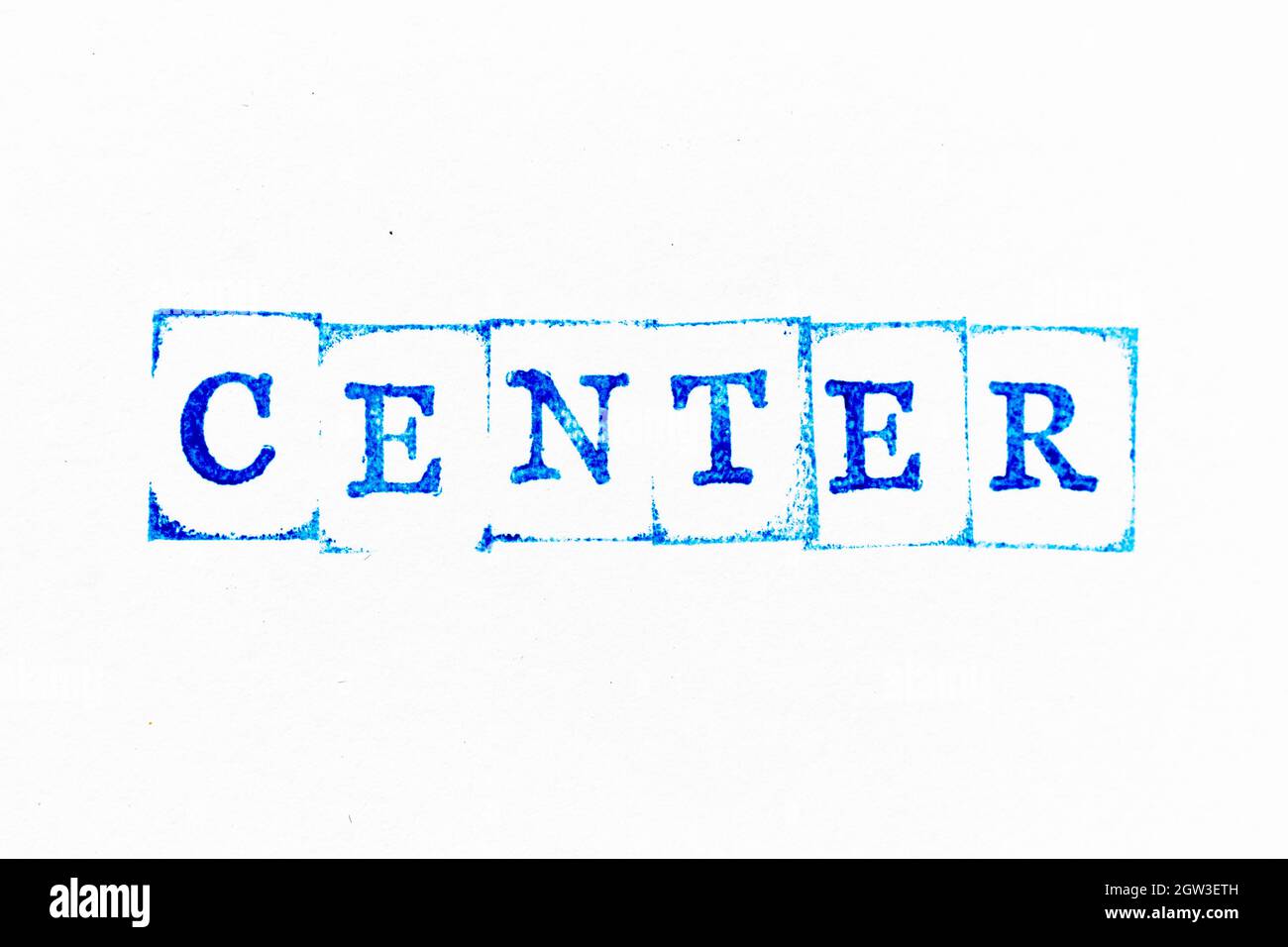Blue color ink rubber stamp in word center on white paper background ...