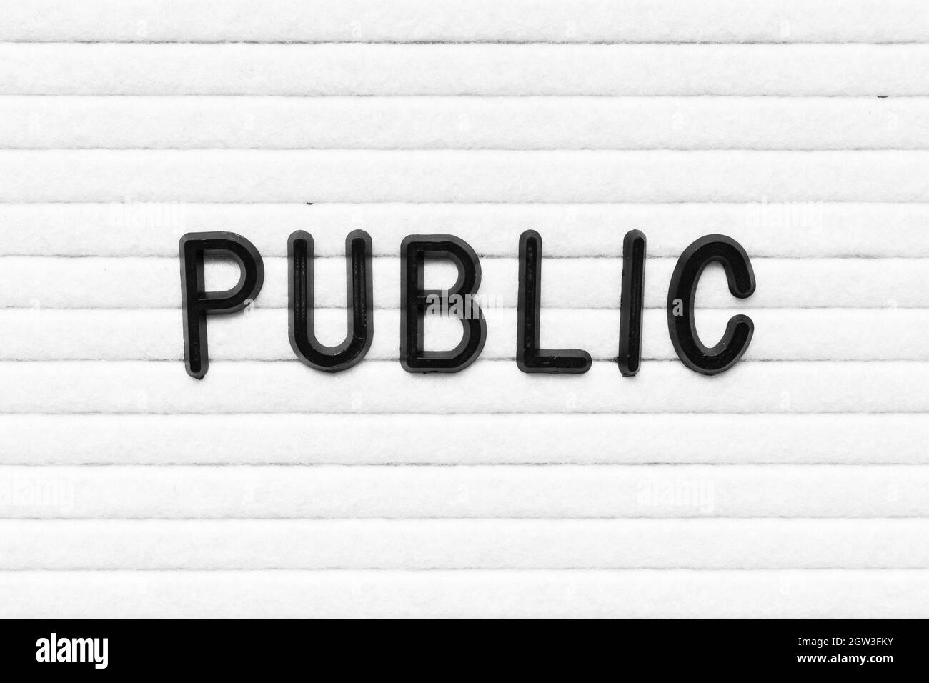 Black alphabet letter in word public on white felt board background ...