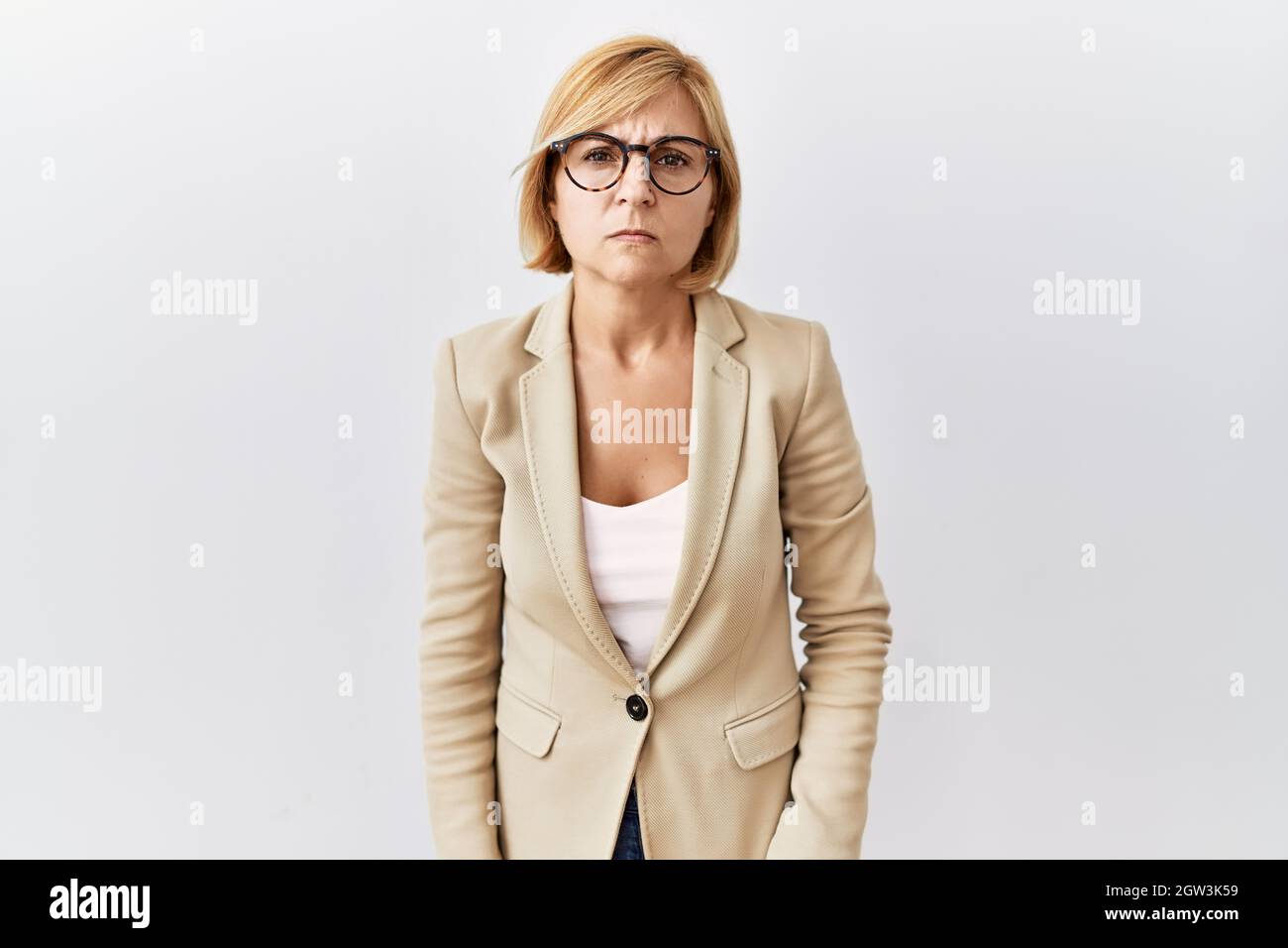 Middle age blonde business woman standing over isolated background ...