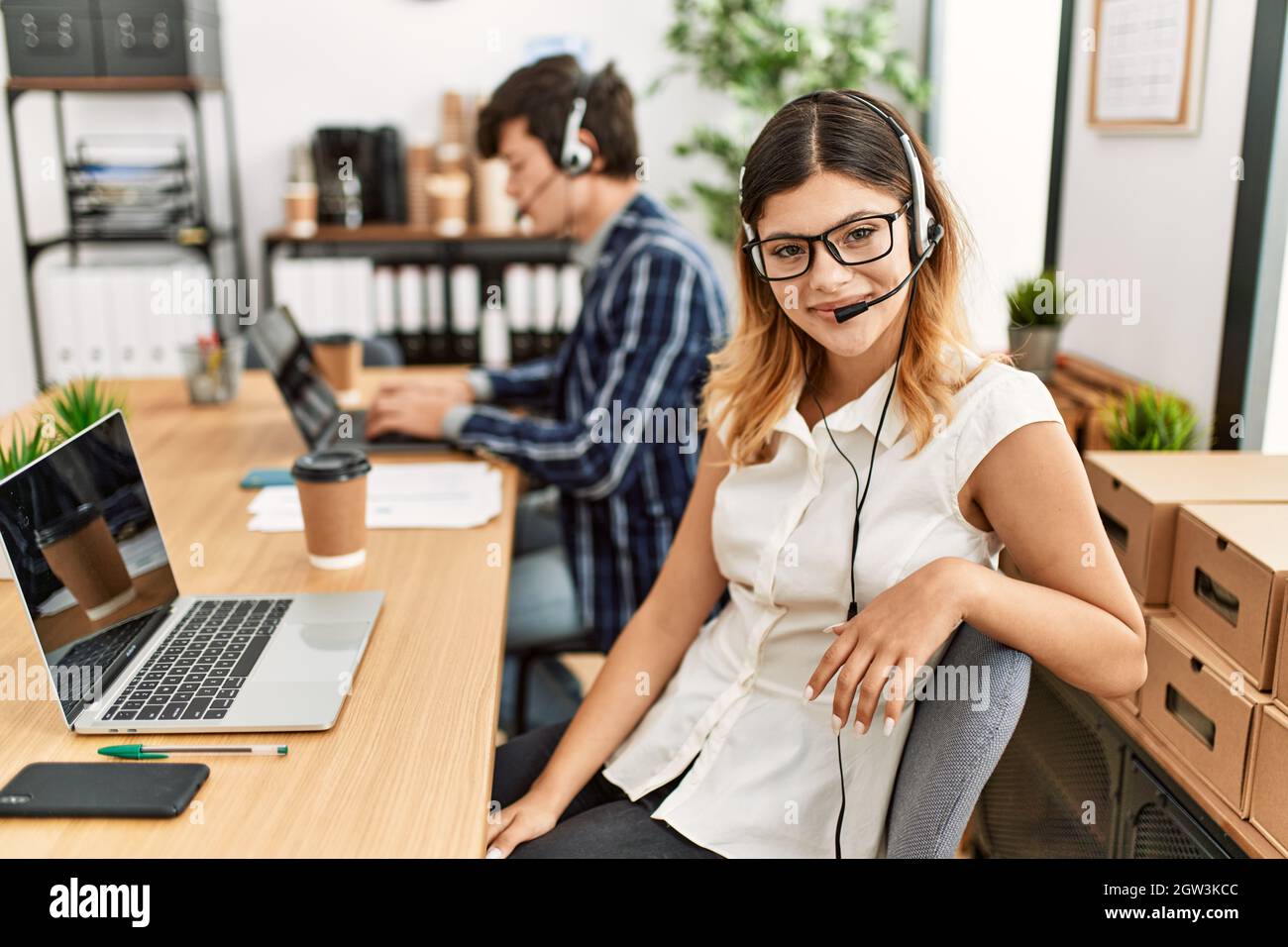 Two call center agents smiling happy working at the office Stock Photo ...