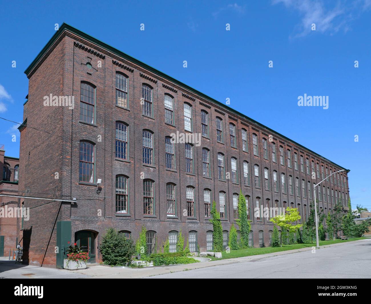 Old fashioned long brick factory type building Stock Photo - Alamy