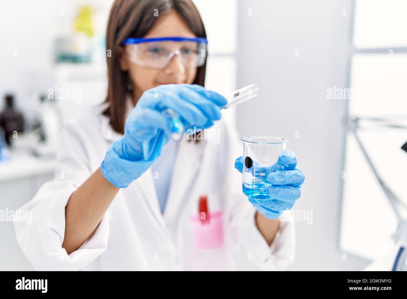 Young hispanic girl working at laboratory Stock Photo - Alamy
