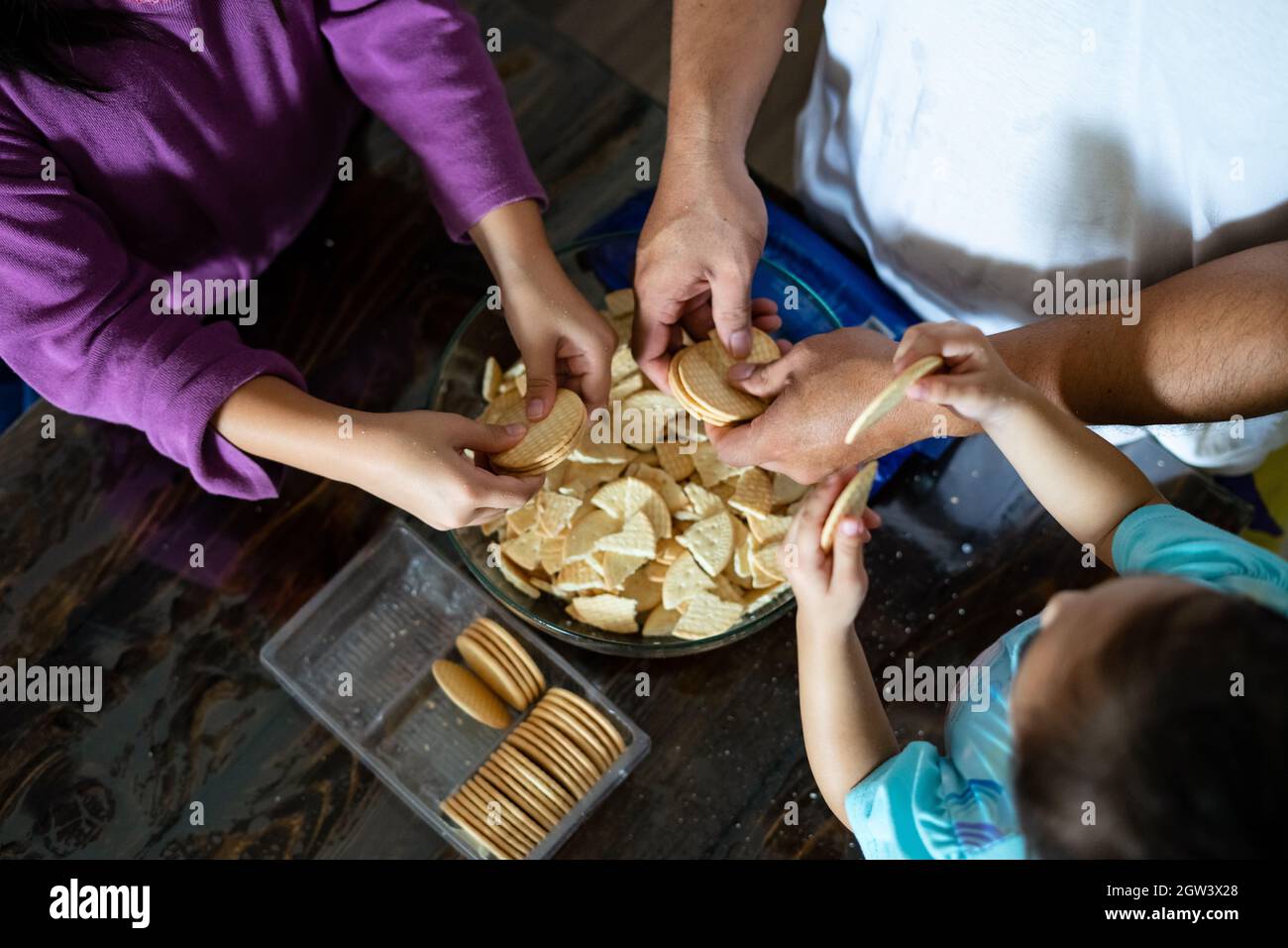Hands Making Malaysian Triple Chocolate Dessert. Crushing The Cookies ...