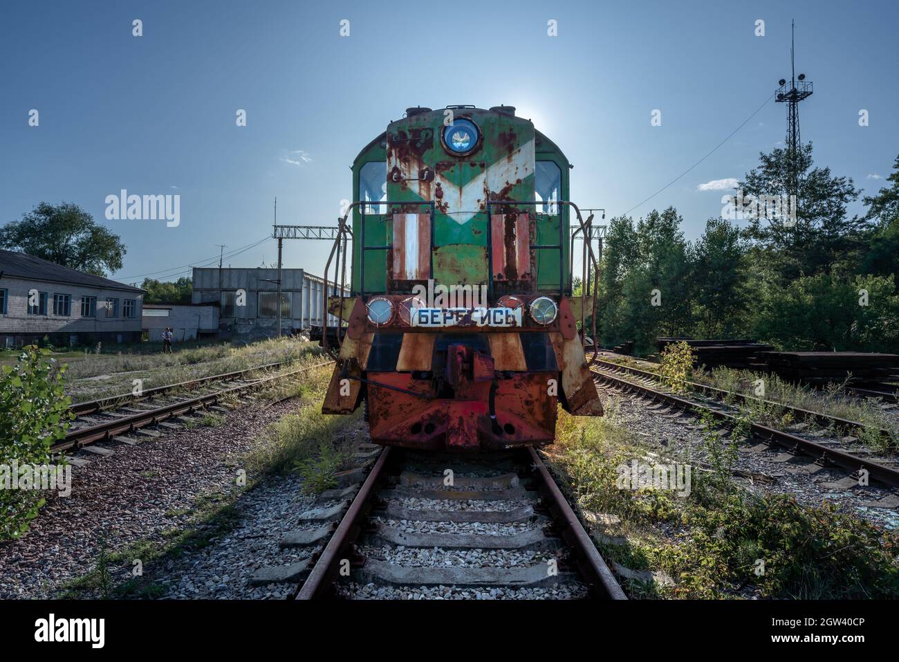 Old rusty train in Yaniv Railway Station - text says: Beware ...