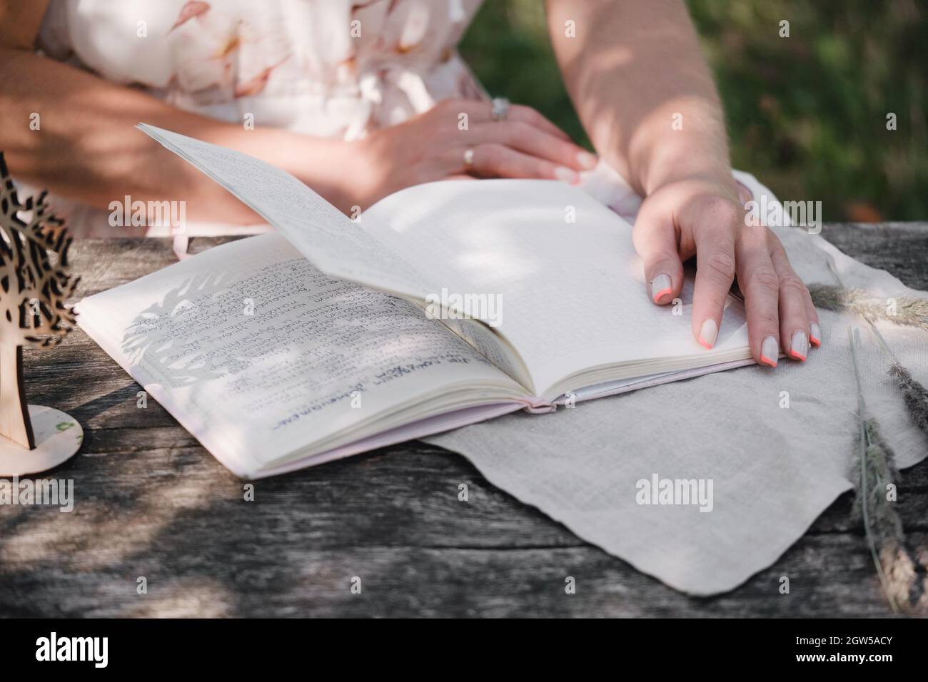 Woman writing, reading diary on the wooden table. Romantic memories ...
