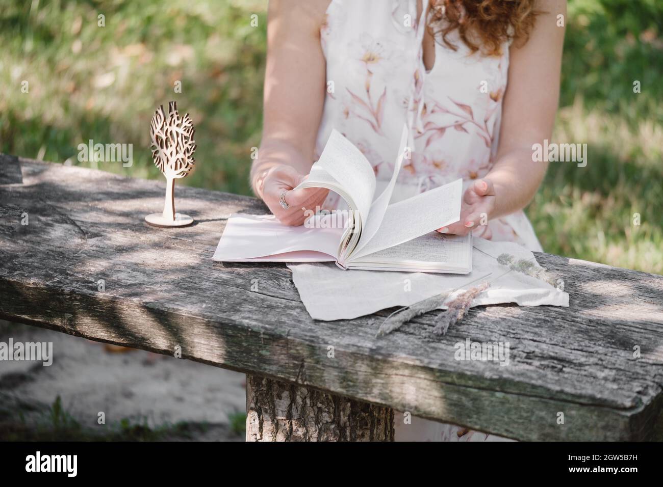 Woman writing, reading diary on the wooden table. Romantic memories ...