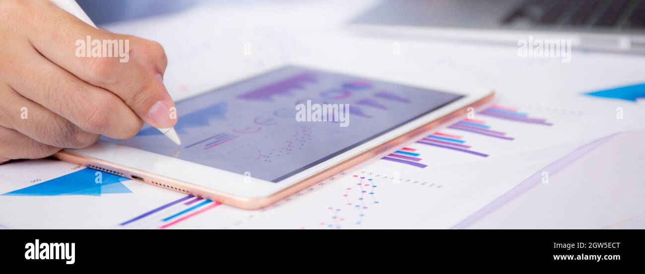 Businessman planning about graph and chart of investment with report ...