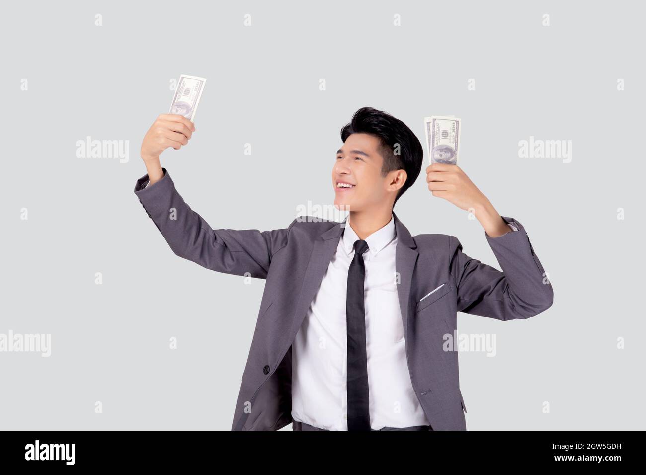 Young asian business man holding money dollar isolated on white ...
