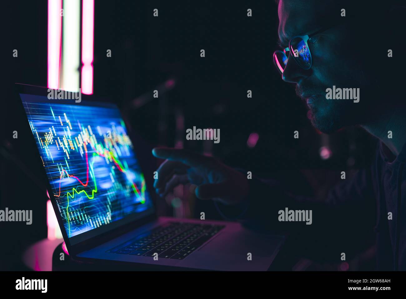 A man stares intently at a computer screen late at night. Concept of a ...