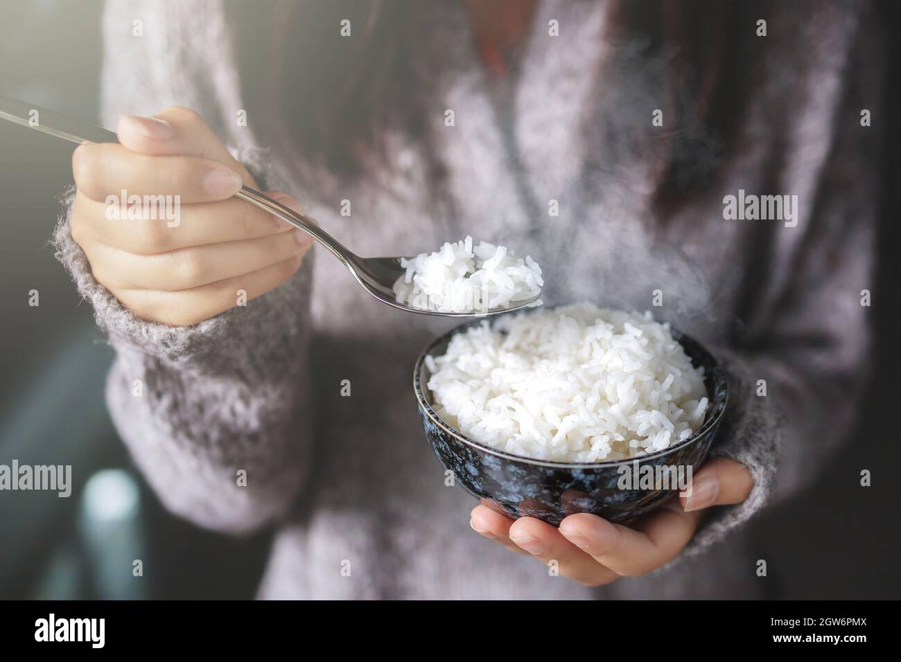 Woman eat brown rice hi-res stock photography and images - Alamy