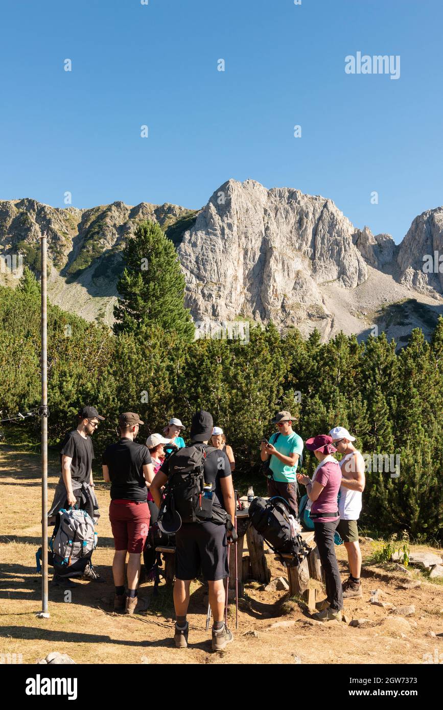 Hiking in Bulgaria. Mixed group of hikers at the Sinanitsa marble peak ...