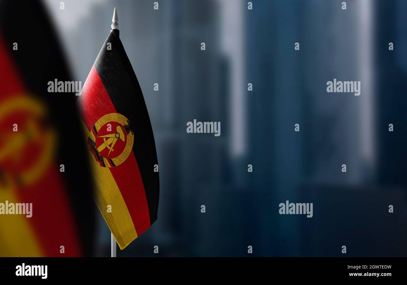 Small flags of GDR on a blurry background of the city Stock Photo - Alamy