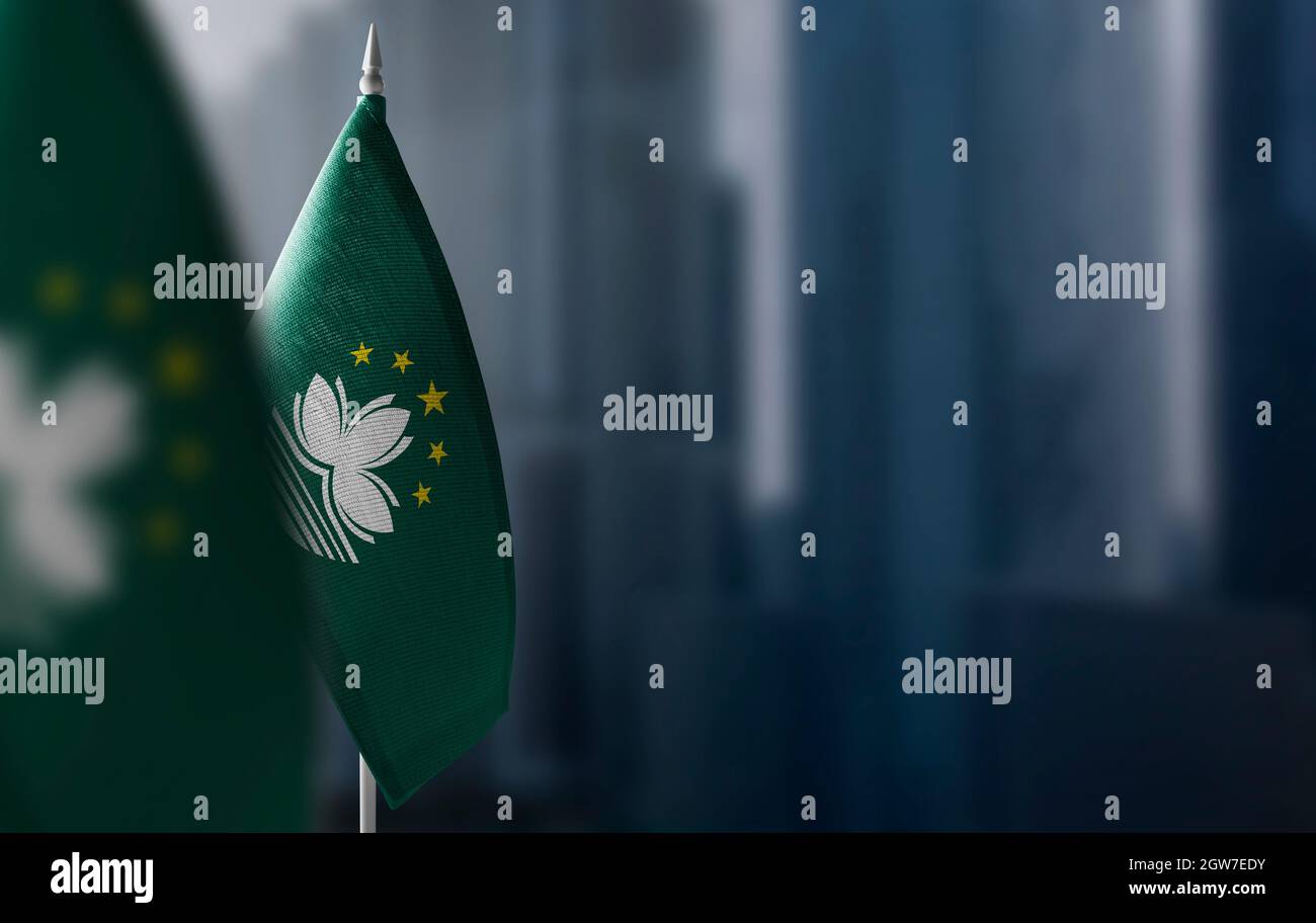 Small flags of Macao on a blurry background of the city Stock Photo - Alamy
