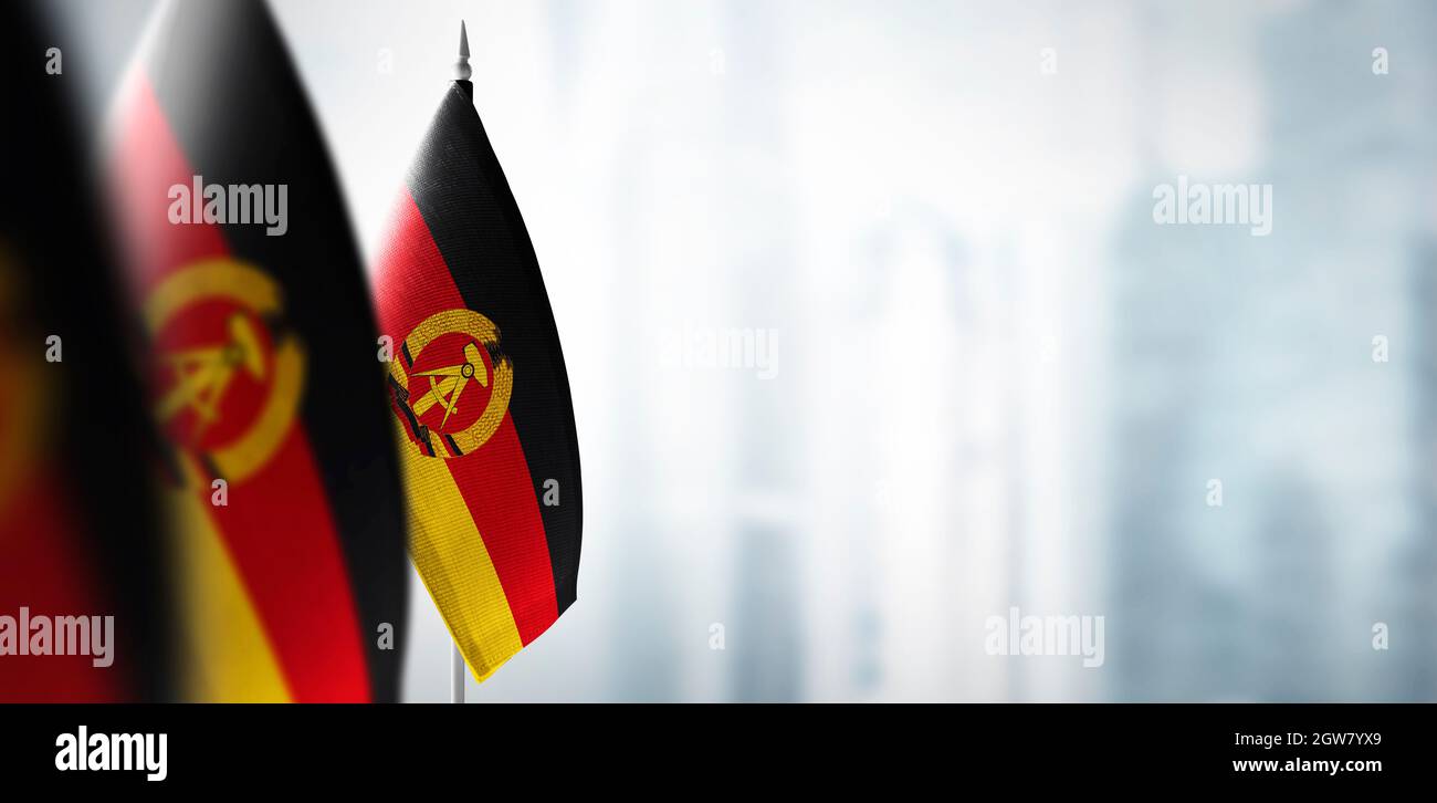 Small flags of GDR on a blurry background of the city Stock Photo - Alamy