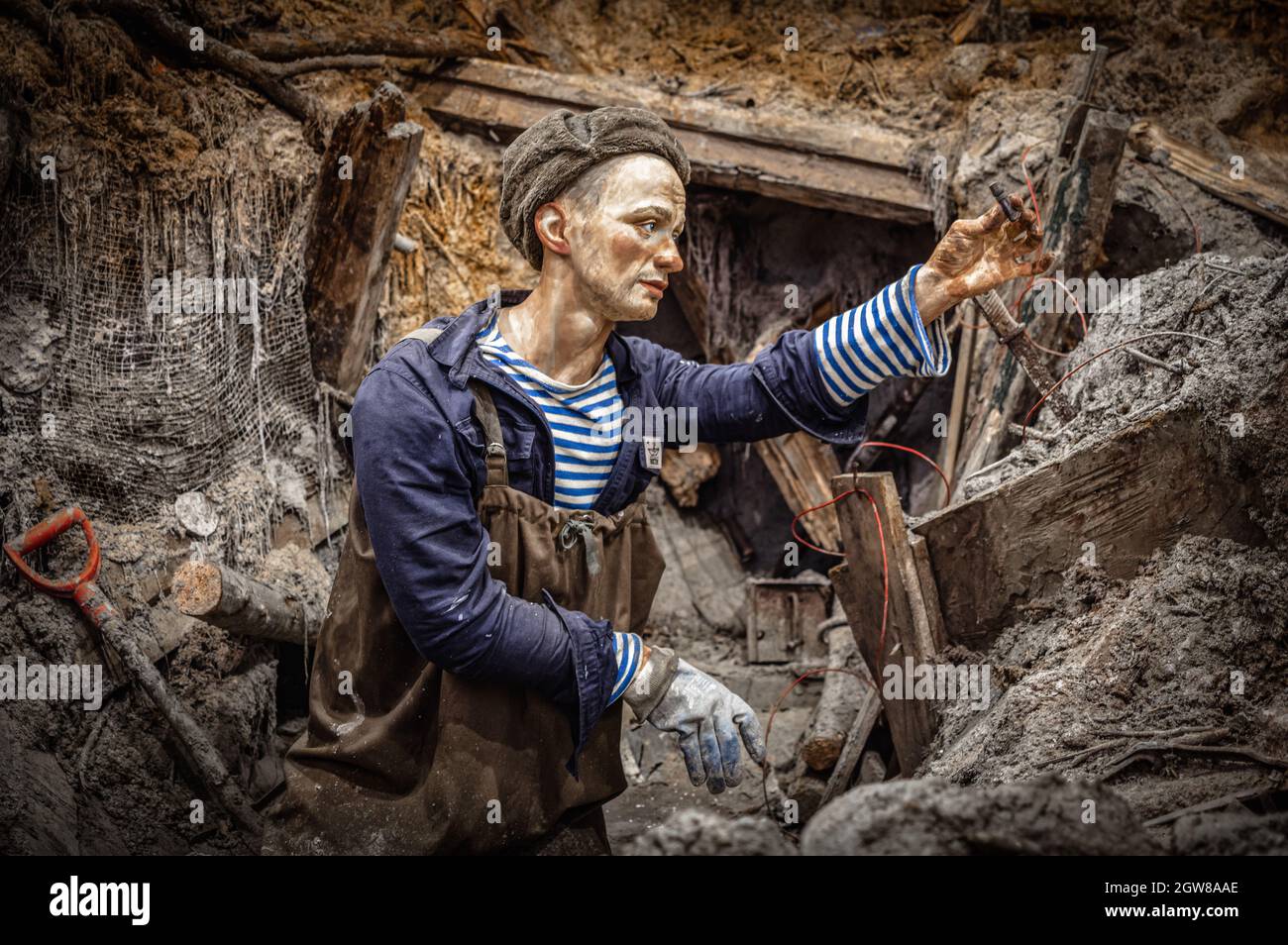 Soiled Soviet soldier digging a trench. WWII historical diorama titled ...