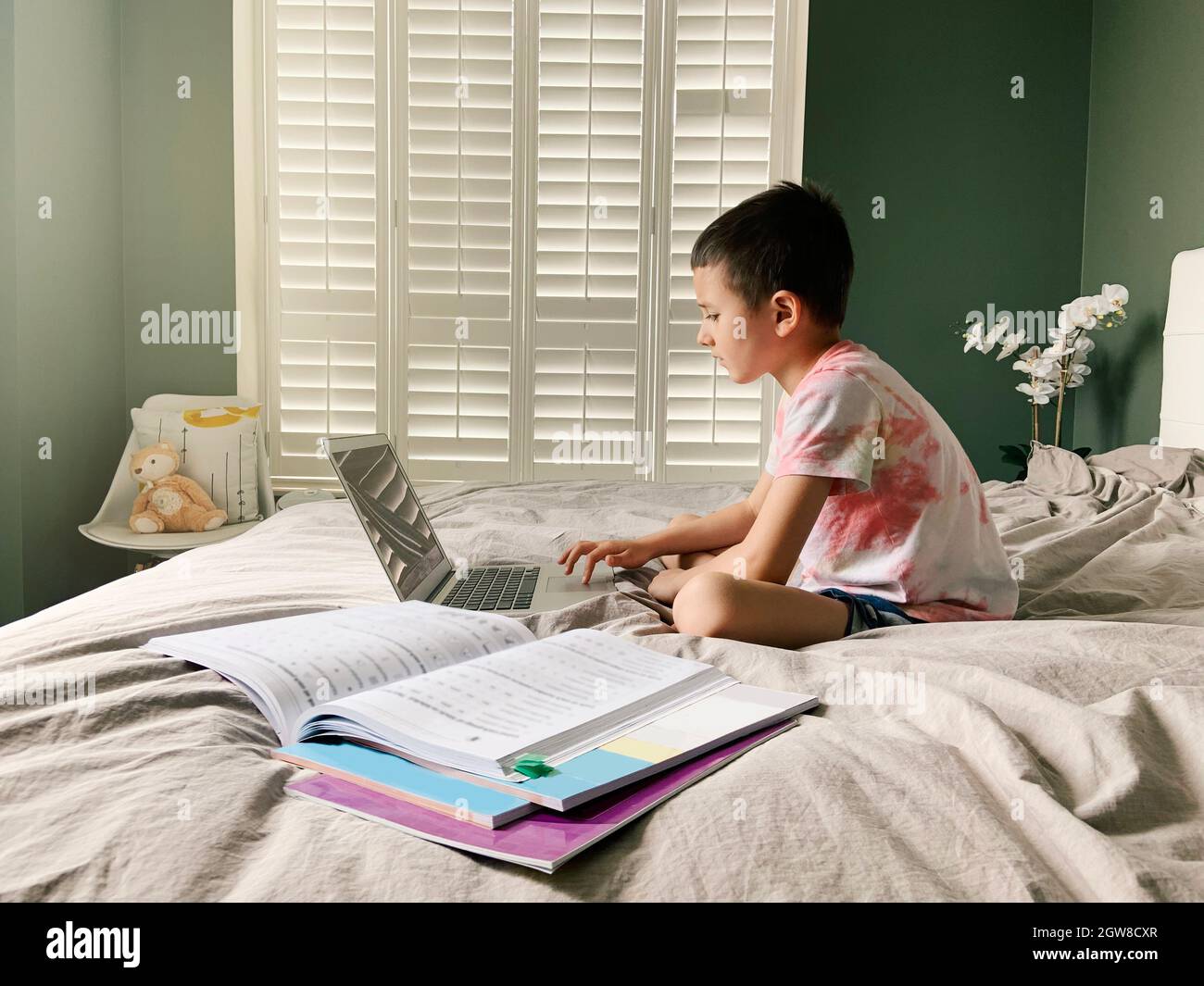 Boy does homework in bedroom hi-res stock photography and images - Alamy