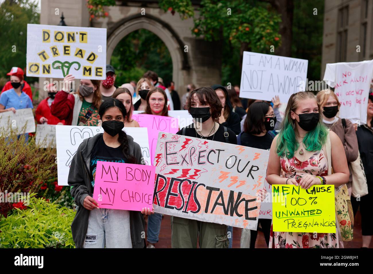 A woman holds a placard saying “Expect Our resistances,” as ...