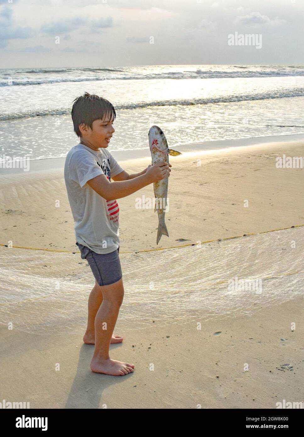 Boy holding big fish hi-res stock photography and images - Alamy