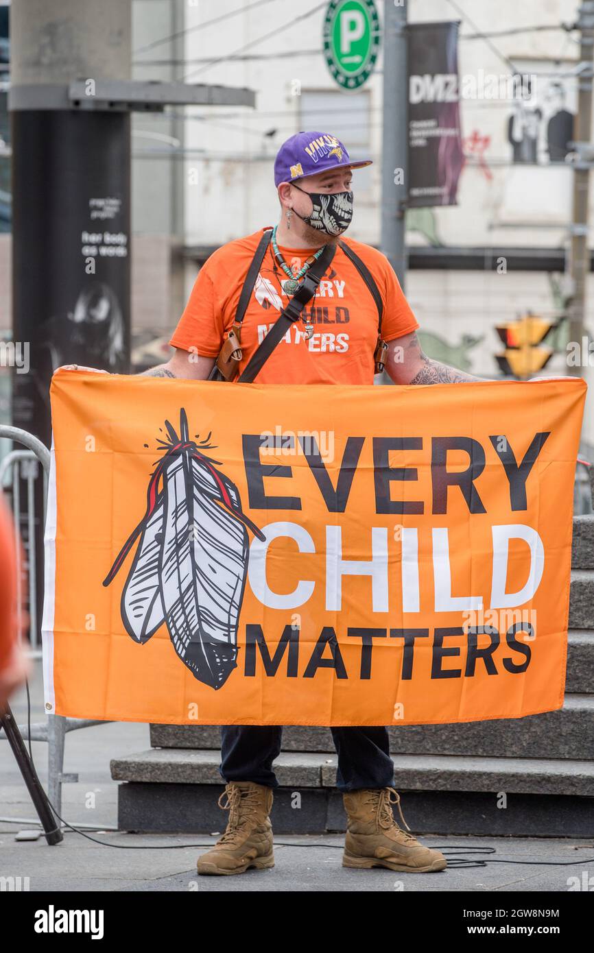 A participant holds a banner during the Orange Shirt Day and National ...