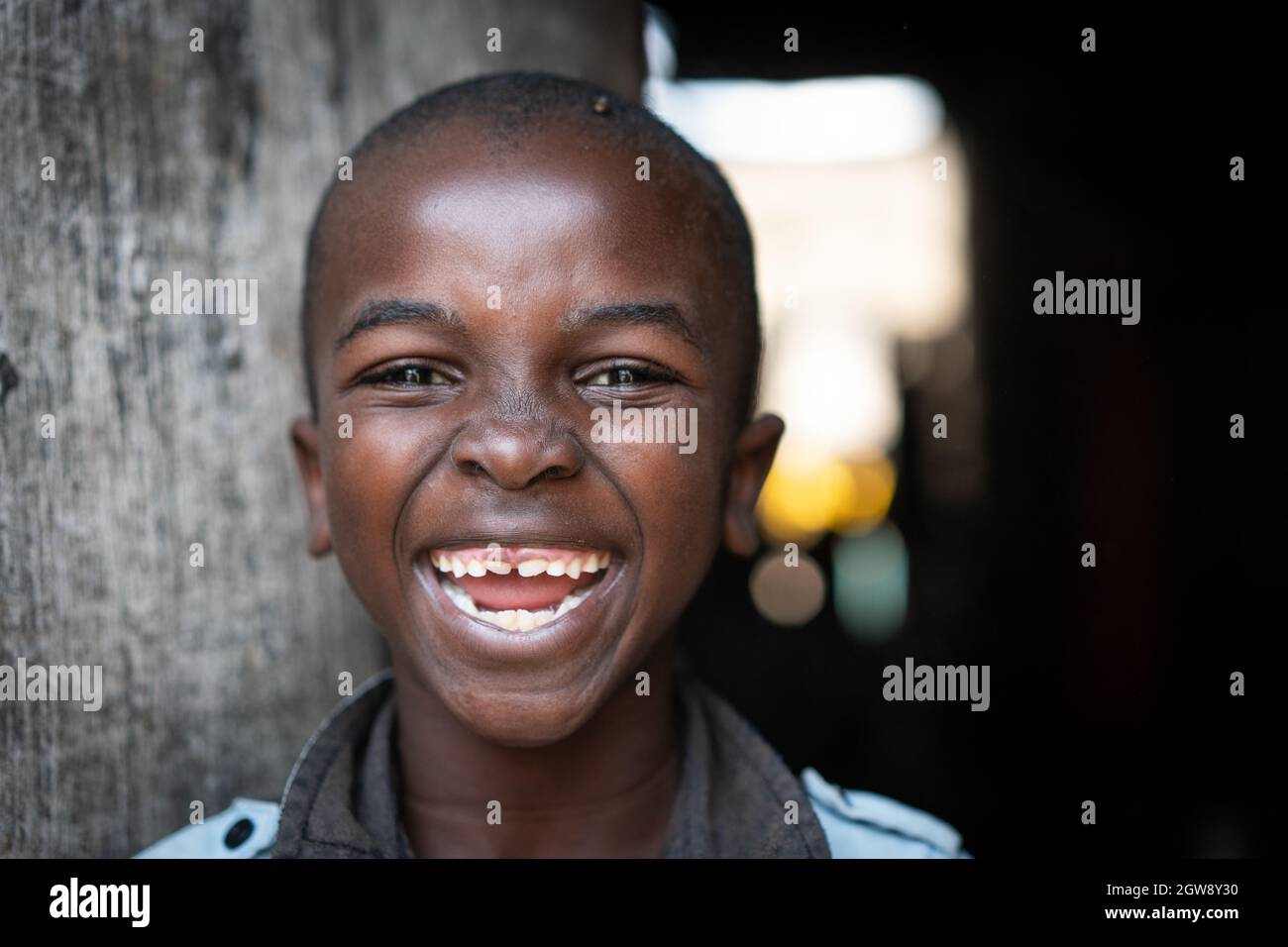 Cute happy poor black child at home Stock Photo - Alamy