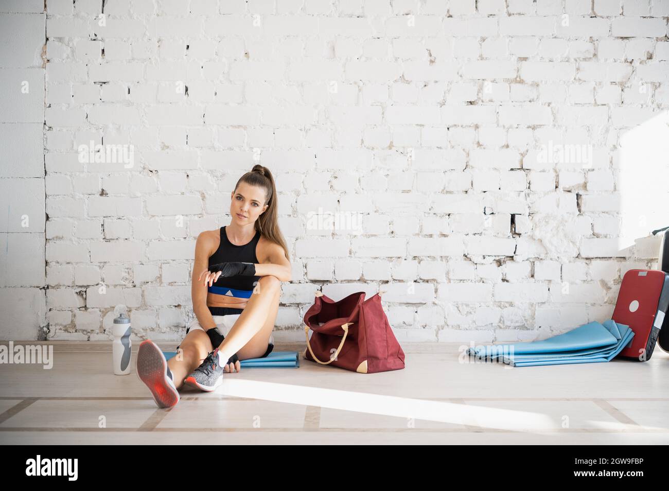 Female fighter exhausted after exercise feeling dehydration, drinks ...