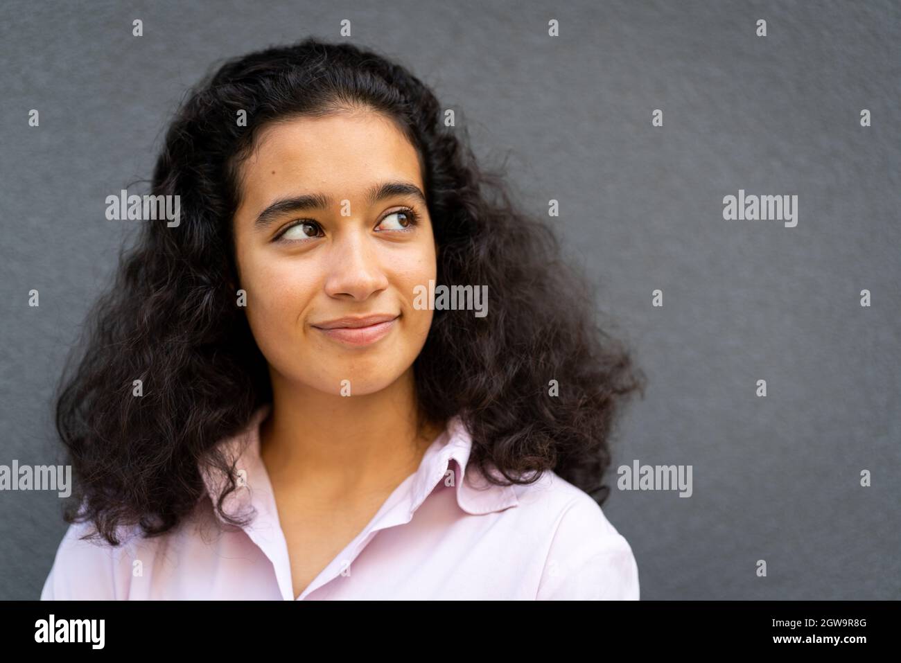 One positive person portrait against grey wall Stock Photo - Alamy