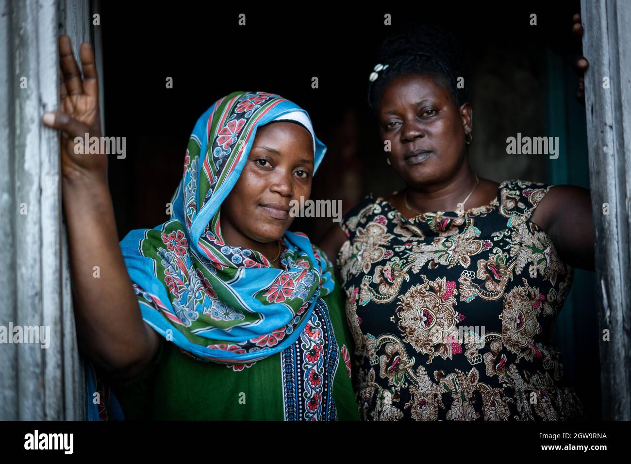 Two best friends standing on the door of the house Stock Photo - Alamy