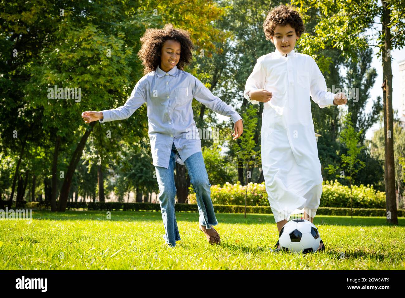 cinematic image of a family from the emirates spending time at the park ...