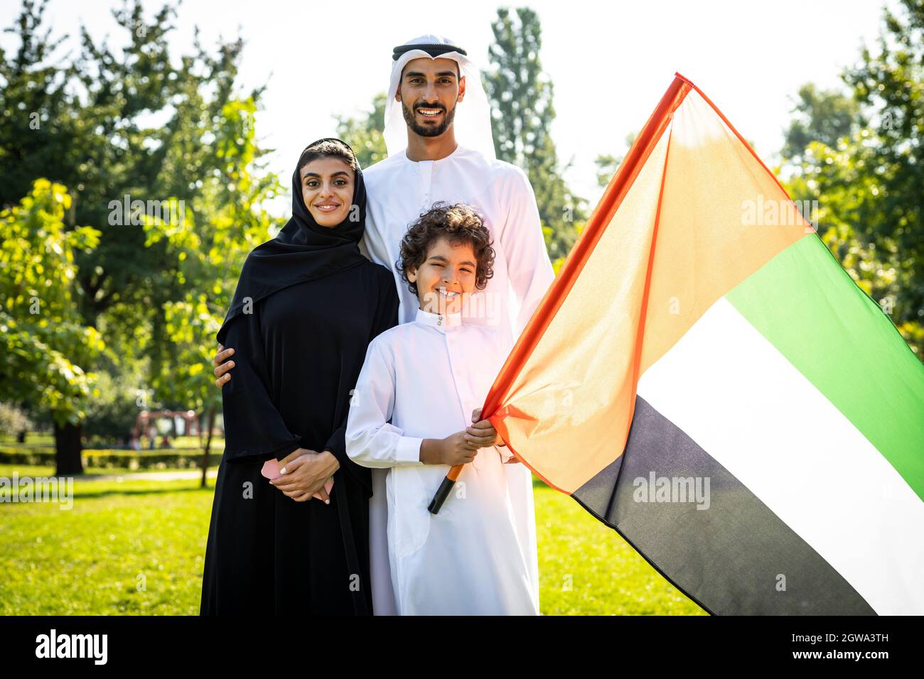 cinematic image of a family from the emirates spending time at the park ...