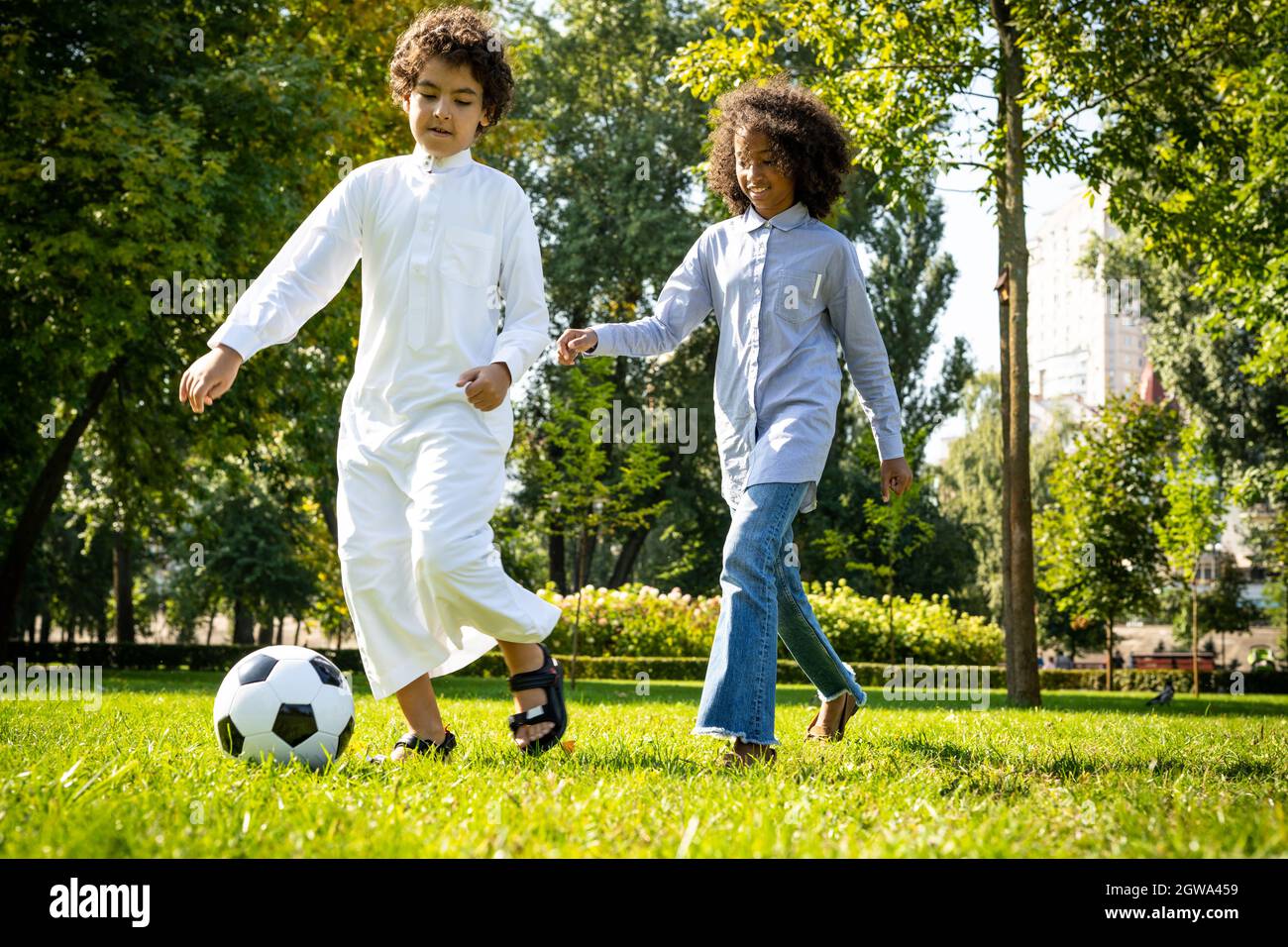 cinematic image of a family from the emirates spending time at the park ...