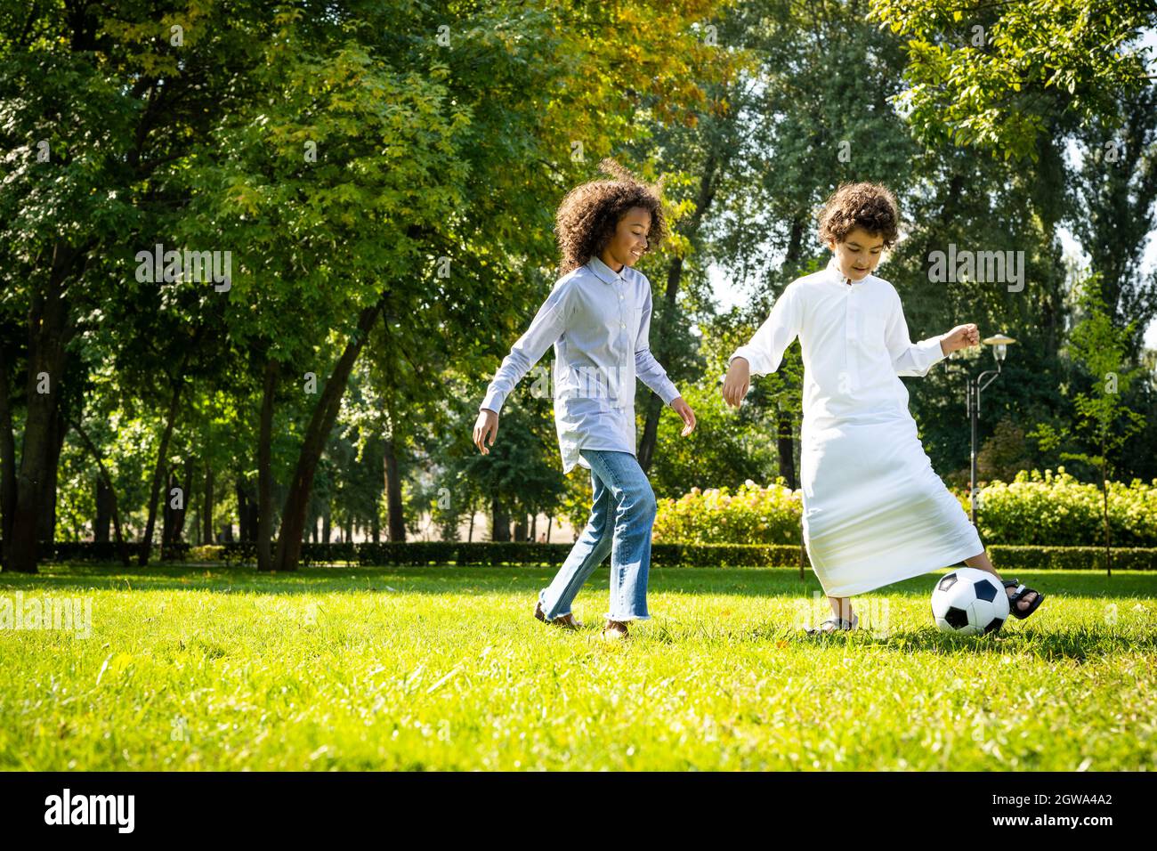 cinematic image of a family from the emirates spending time at the park ...