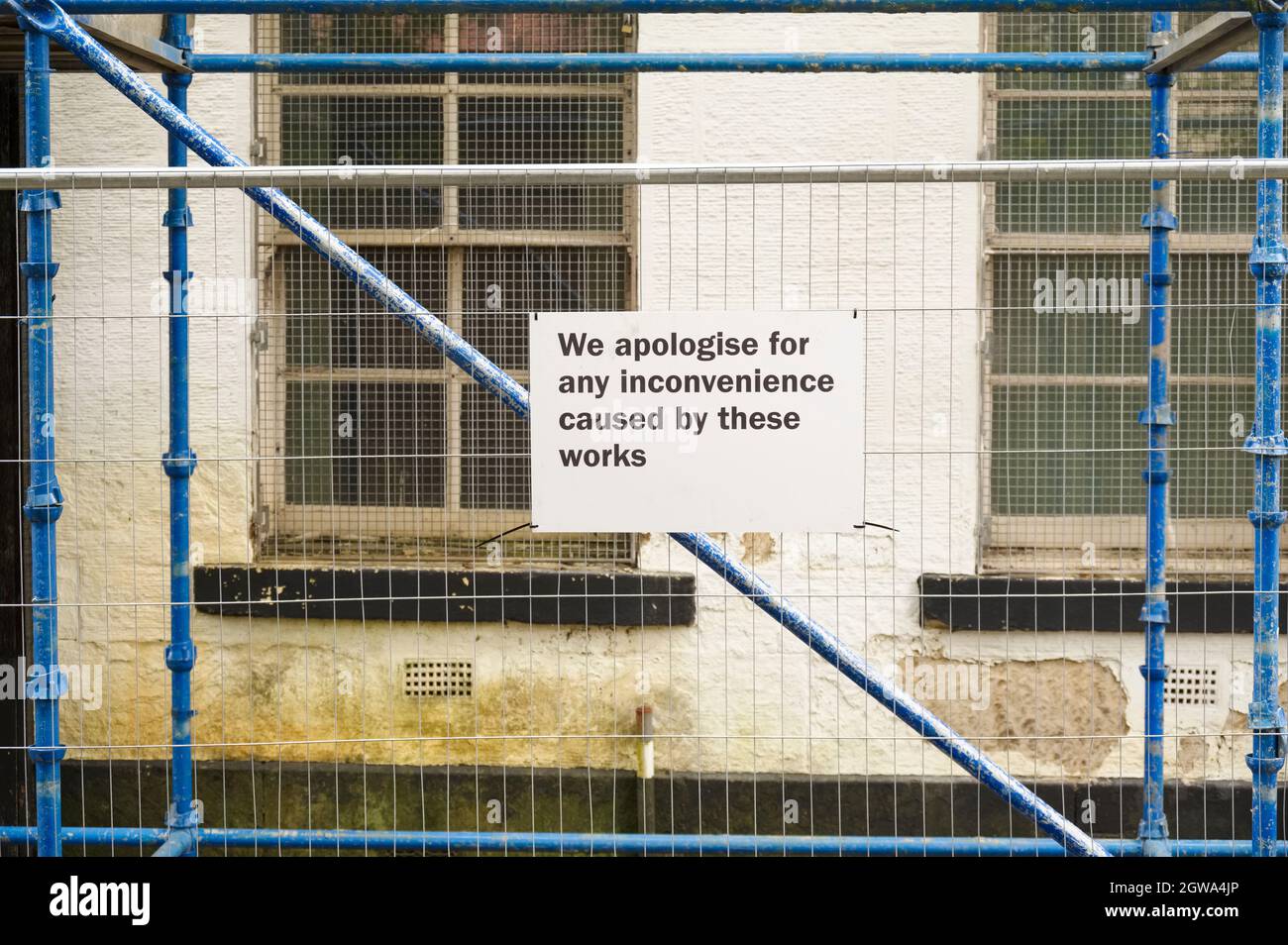 Apology sign at construction site during works Stock Photo - Alamy