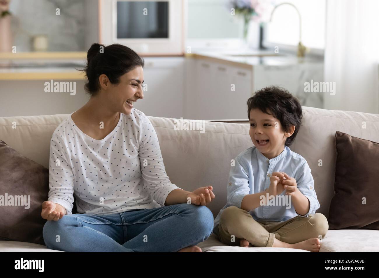 Happy young indian mixed race family doing yoga exercises Stock Photo ...