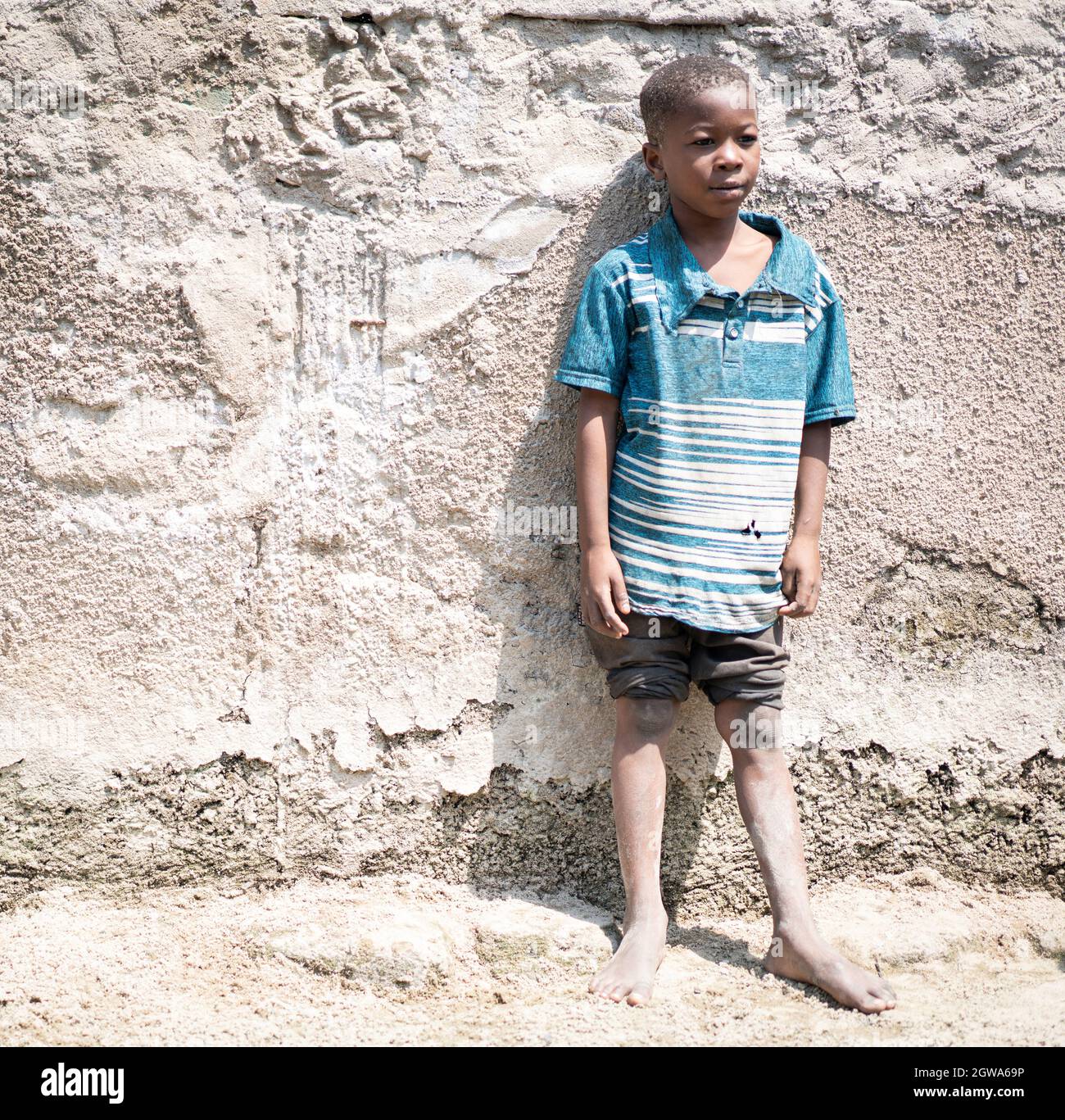 African black boy portrait standing near his poor house alone Stock ...