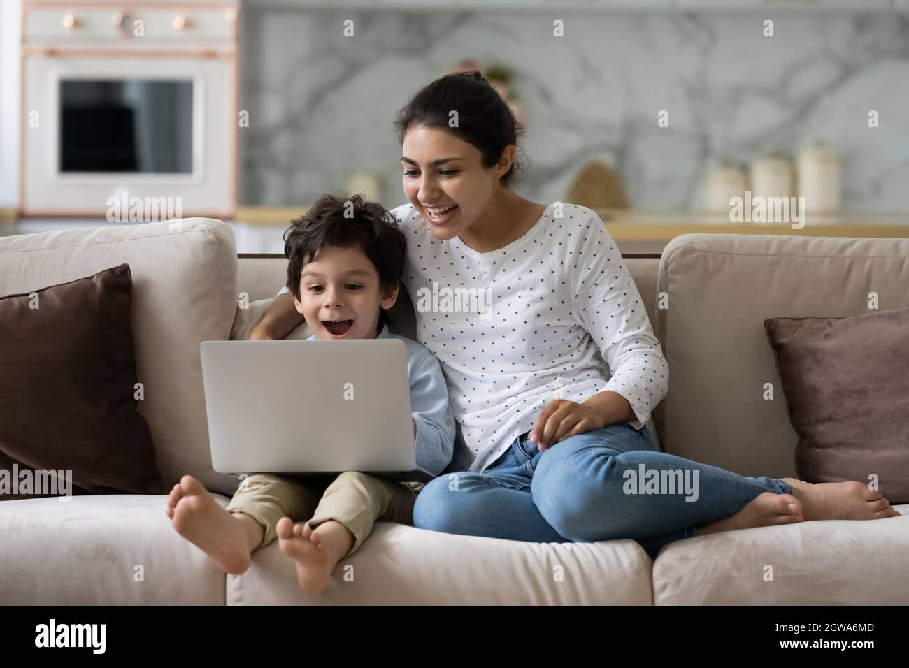 Happy indian family using computer at home Stock Photo - Alamy