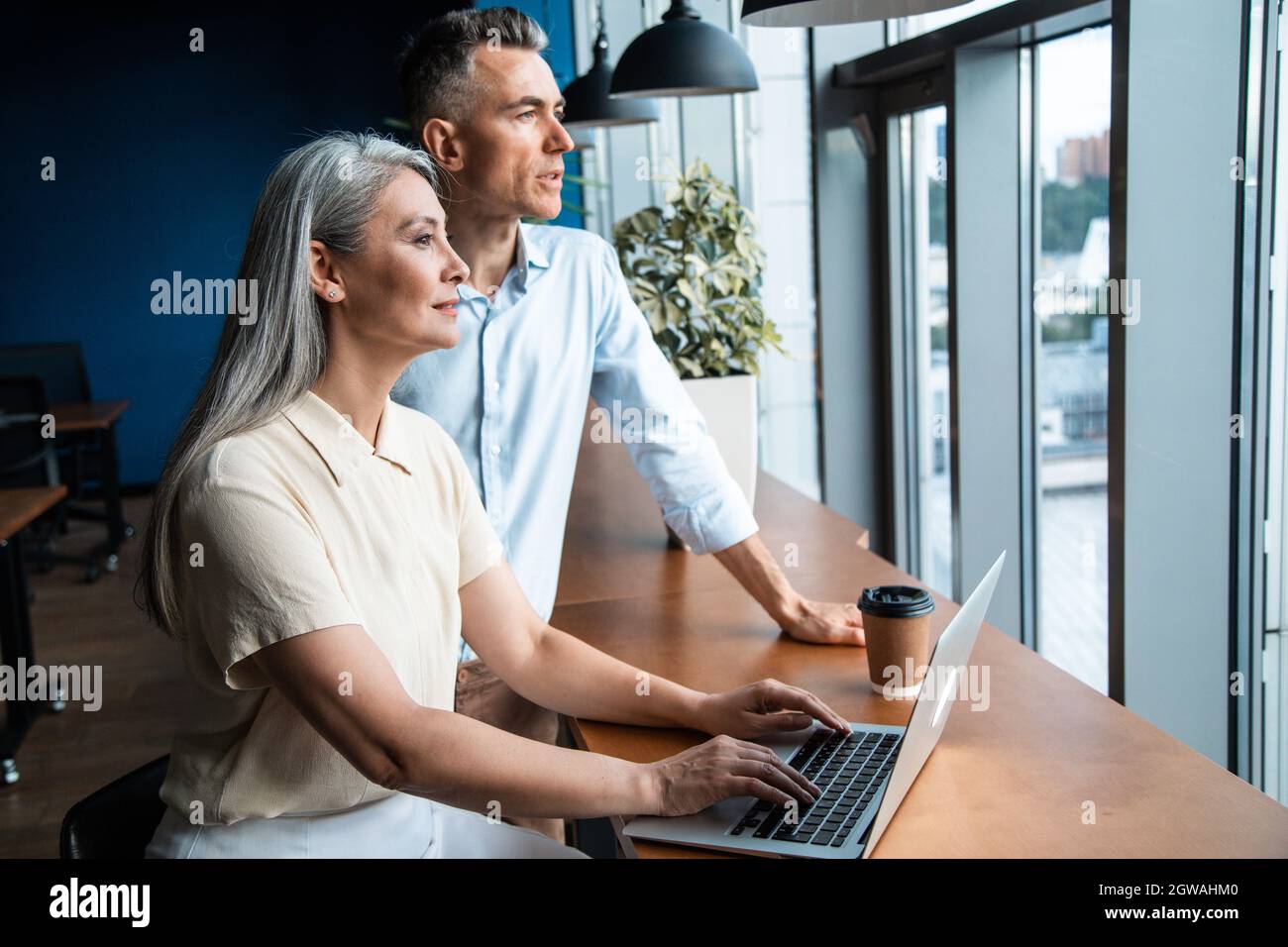 cinematic image of a multiethnic business team. Two employees working ...