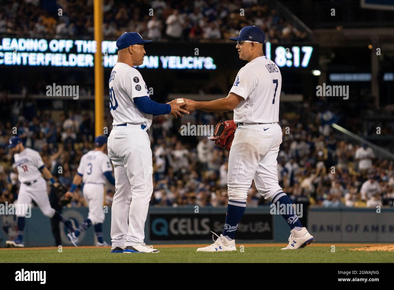 Los Angeles Dodgers manager Dave Roberts (30) takes the ball from ...