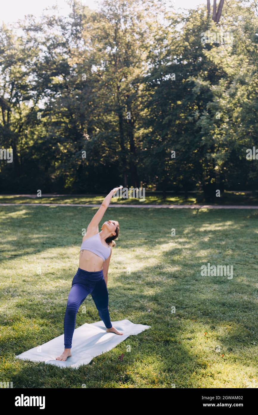 Full Length Of Eoman In Warrior Pose Doing Yoga Stock Photo - Alamy