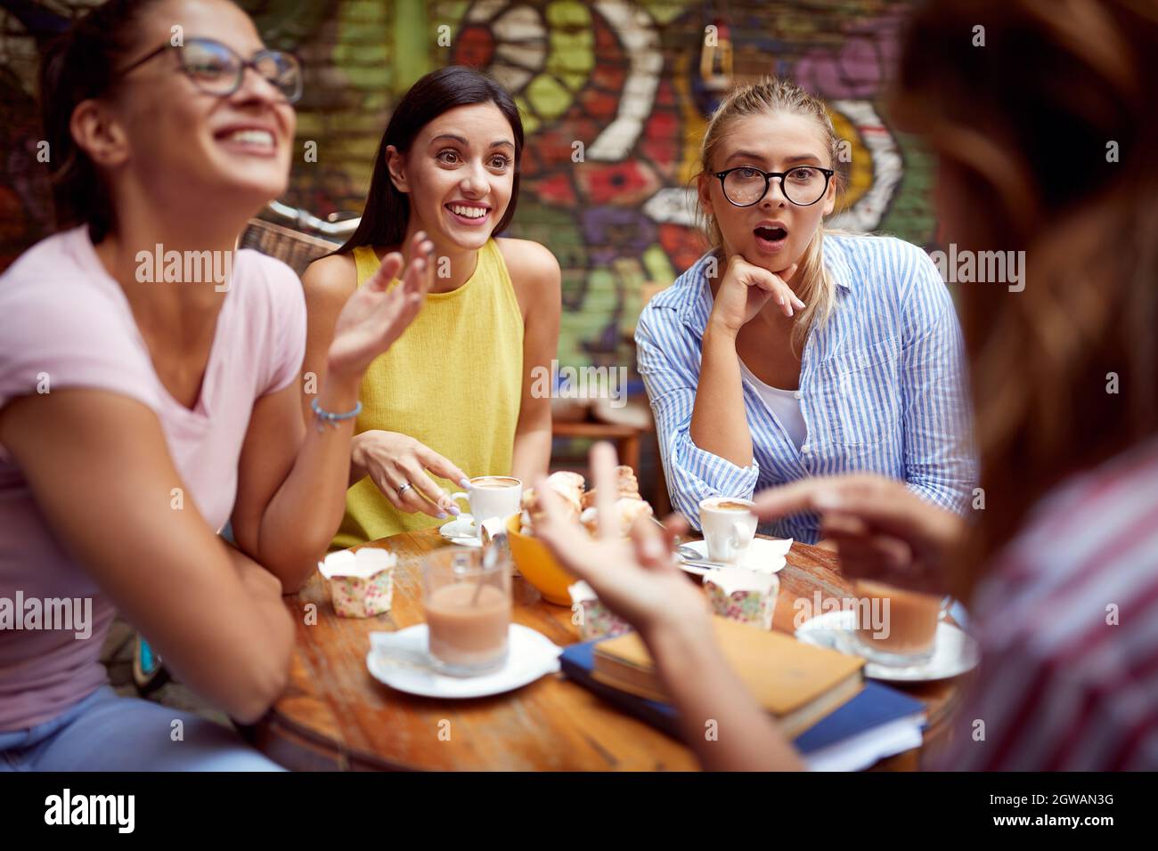 group of caucasian women surprised by the story of their female friend ...
