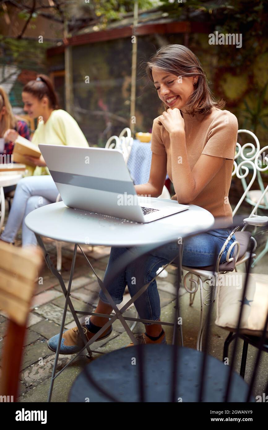 Woman sitting at outdoor cafe hi-res stock photography and images - Alamy