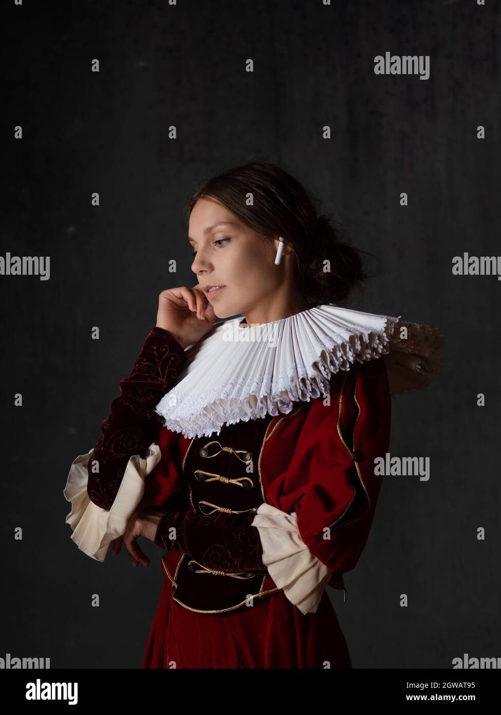 Classics are eternal, art is timeless. young woman in luxurious red ...