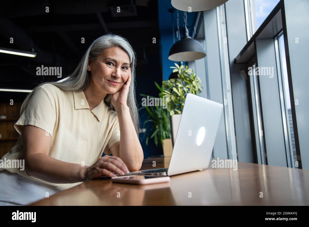 cinematic image of a senior business woman. Portrait of an employee in ...