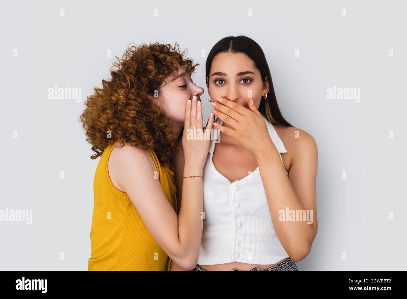 Close up photo of two womans who gossiping on white background. High ...