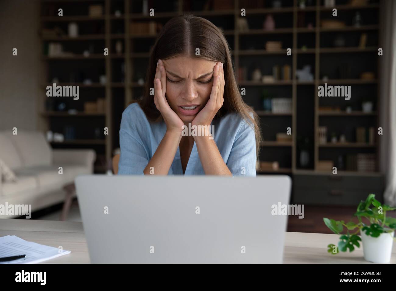Upset unhappy employee tired of work at computer, feeling headache ...