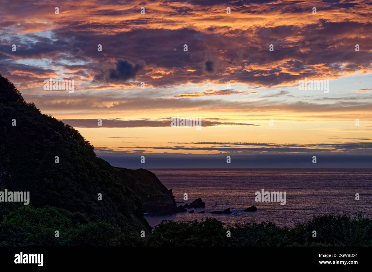 Sunset on Lee Bay and Crock Point, Exmoor, Devon, UK Stock Photo - Alamy