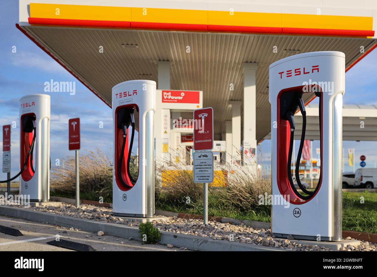 Tesla Superchargers seen at a Shell petrol station. (Photo by Filip ...